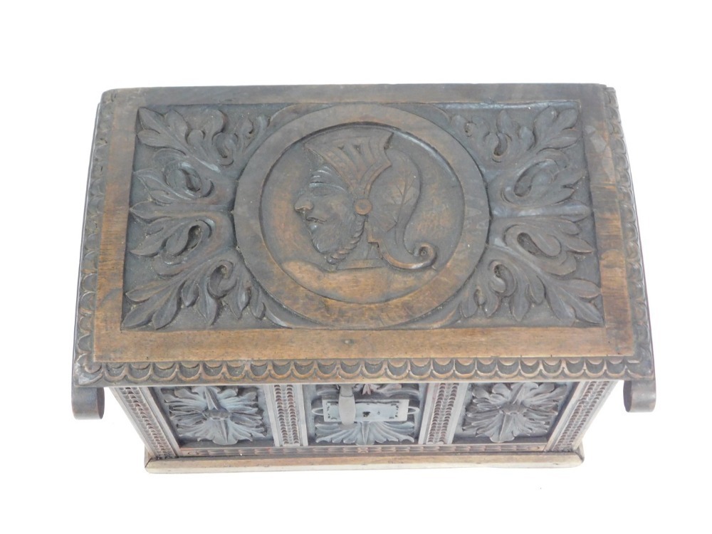 A 18thC carved oak bible box, the lid carved with a central roundel ...