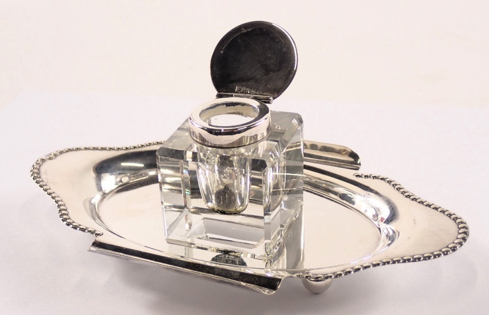 A silver plated inkstand, with a fluted and reeded tray, with two pen ...