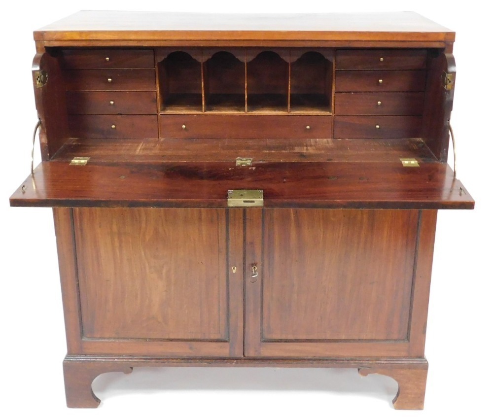 A George III mahogany secretaire chest, the secretaire drawer opening ...