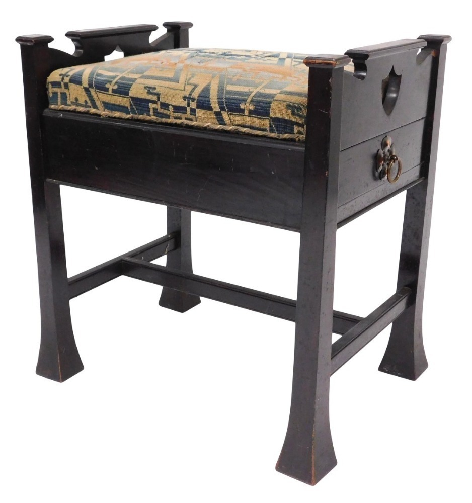 A late 19thC gothic style piano stool, with a hinged top, on tapering ...