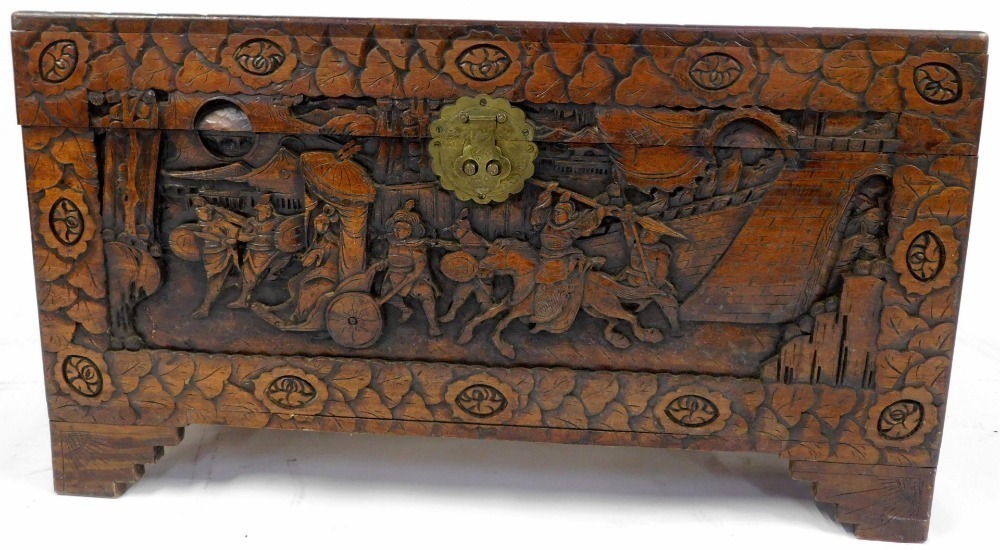 An Oriental camphor wood chest, carved with figures, floral motifs, etc ...