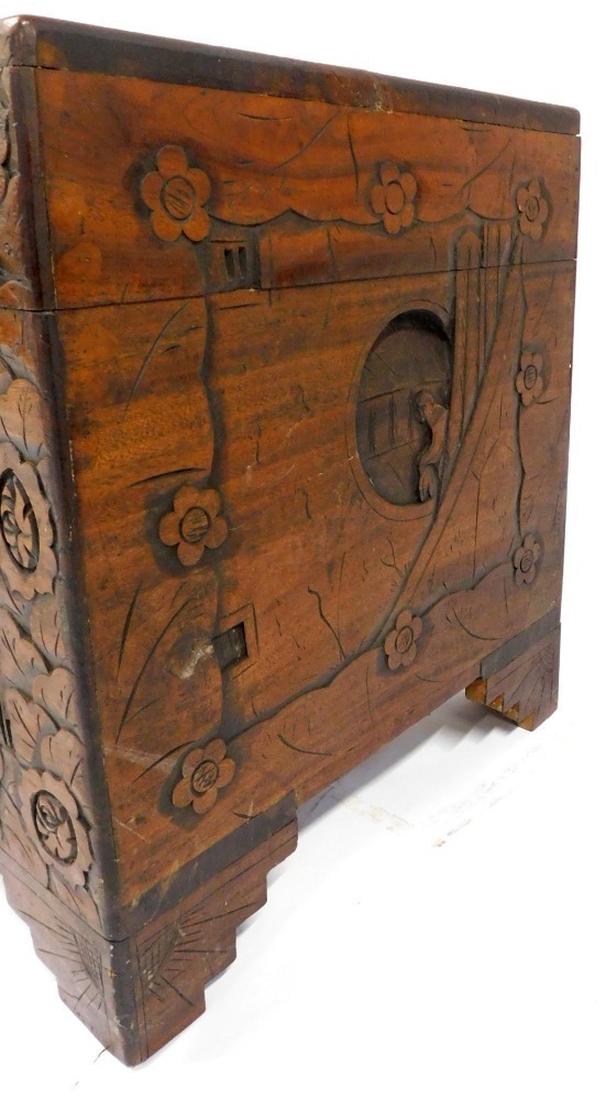 An Oriental camphor wood chest, carved with figures, floral motifs, etc ...