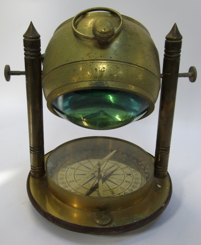 A reproduction brass domed ships compass, the spherical magnifying ...