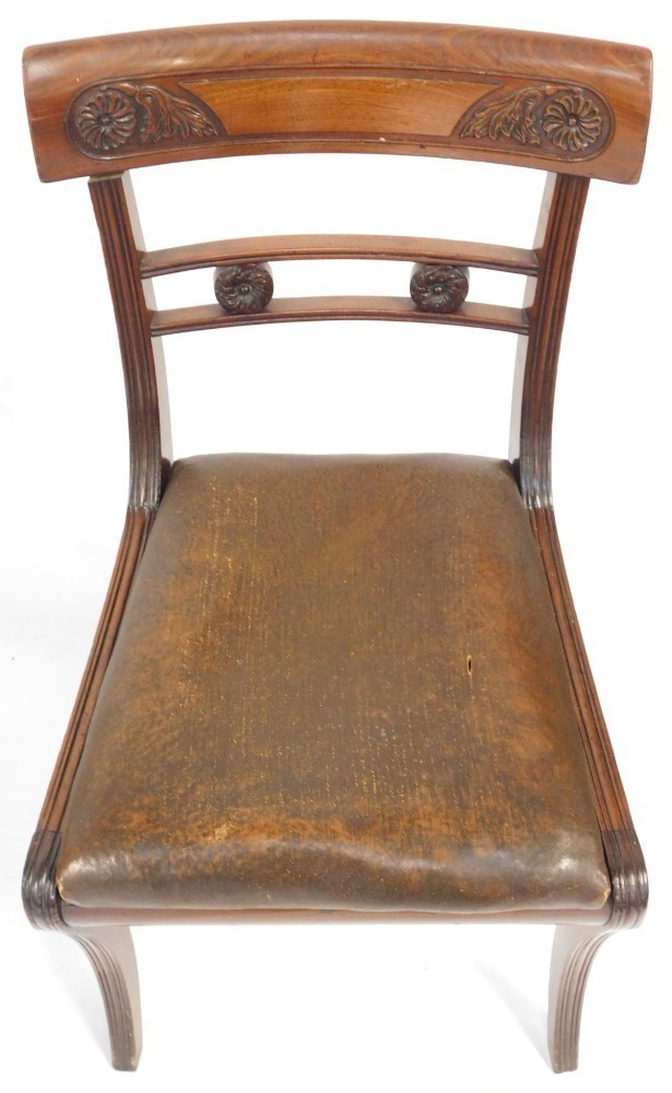 A set of five Regency mahogany dining chairs, each with a floral carved ...