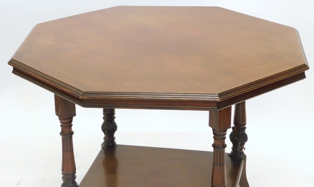 A late Victorian walnut library table, the octagonal top with a moulded ...