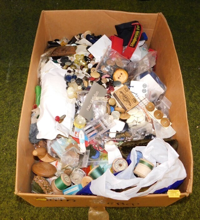 A group of sewing supplies, comprising buttons, thread, zips, needles ...