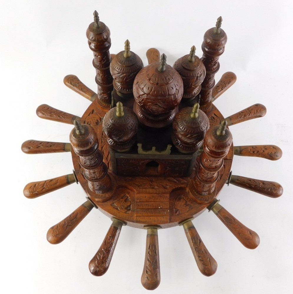 An early to mid 20thC Indian teak cutlery set, of wheel form, the top ...