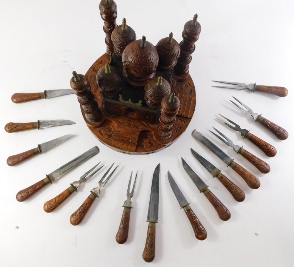 An early to mid 20thC Indian teak cutlery set, of wheel form, the top ...
