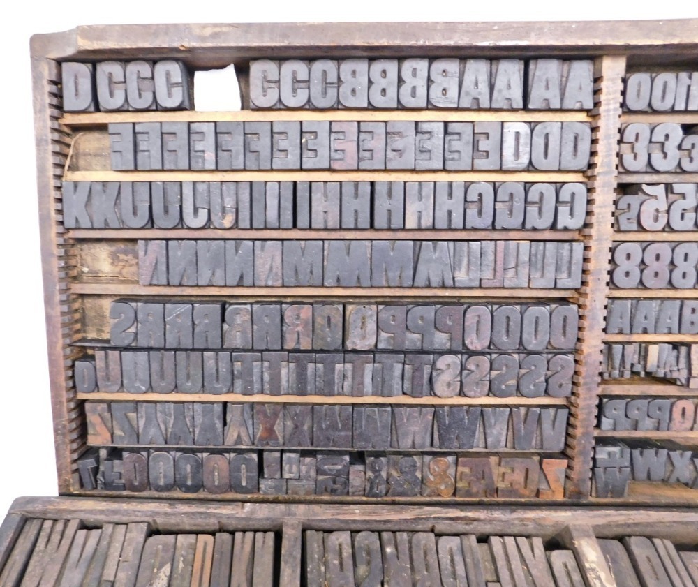 Two trays of printing blocks, to include letters and numbers, various ...
