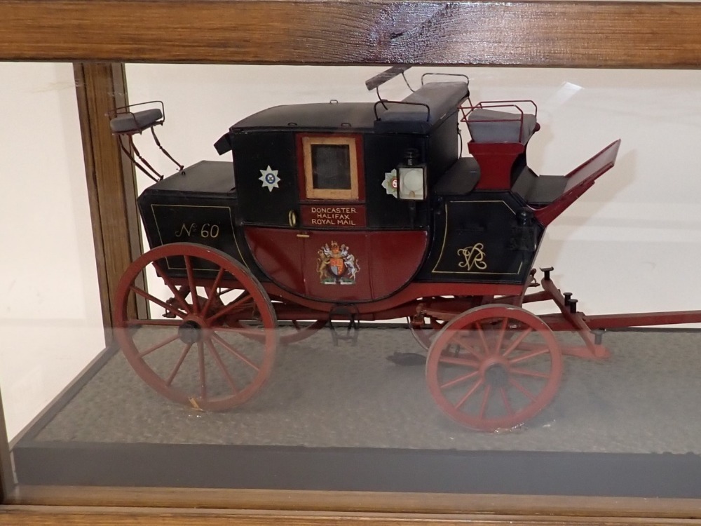 A scale model of the Doncaster to Halifax mail coach, decorated in dark ...