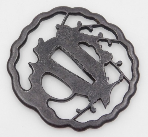 An Edo period iron tsuba, Higo School, akasaka, depicting a bird and ...
