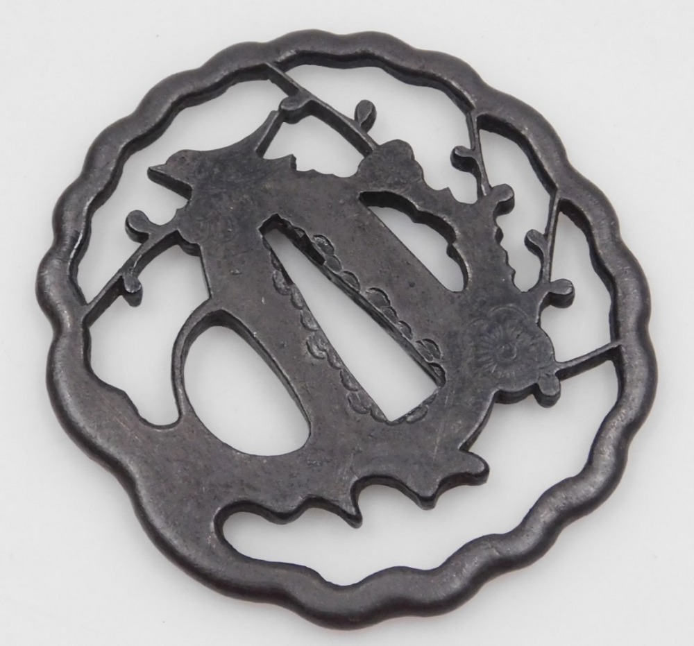 An Edo period iron tsuba, Higo School, akasaka, depicting a bird and ...