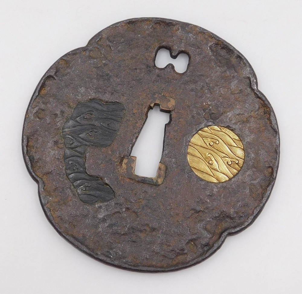 A Muromachi period iron tsuba, Saotome school, of mokko shape ...