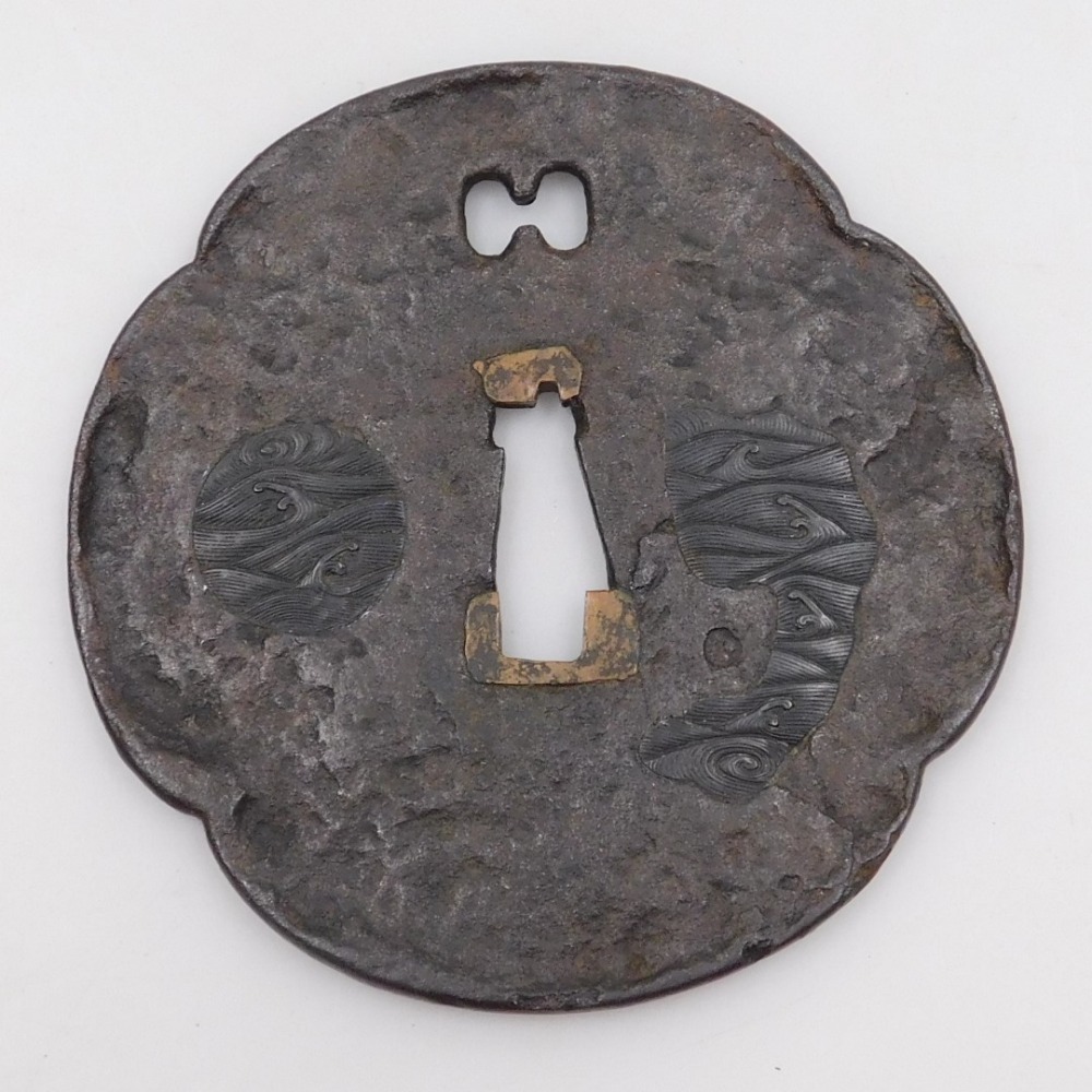 A Muromachi period iron tsuba, Saotome school, of mokko shape ...