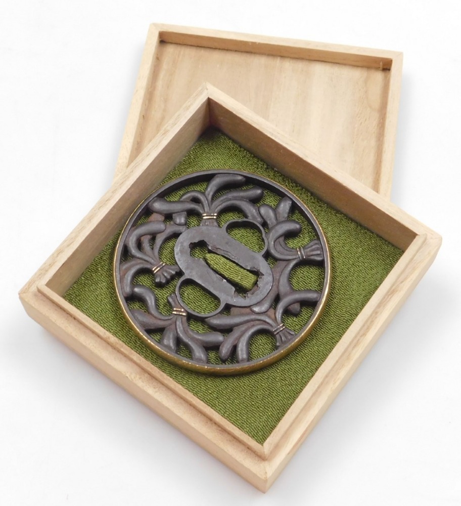 An Edo period iron kyo-shoami tsuba, of circular form, with repeating ...