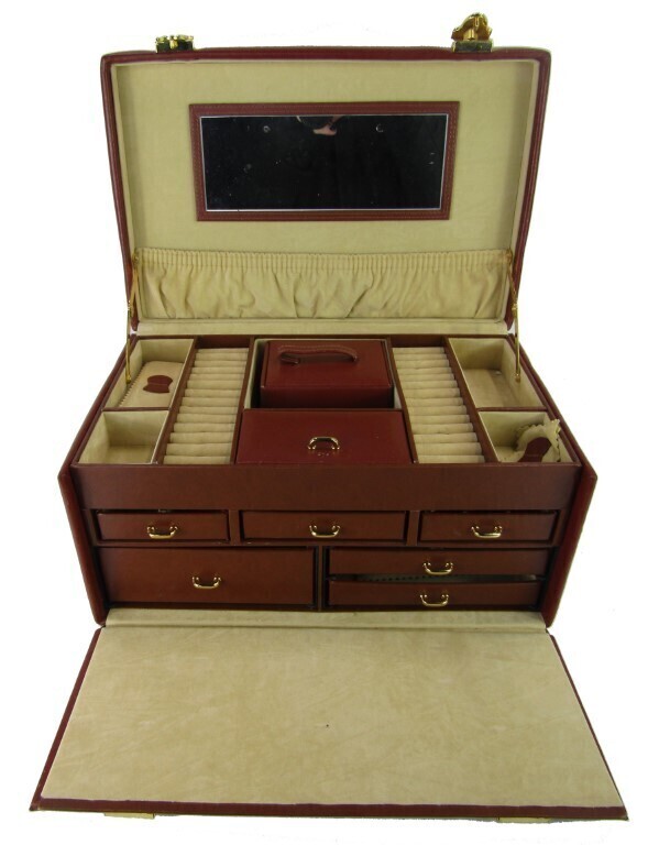 A brown leatherette jewellery box, of three tiered design with brass ...