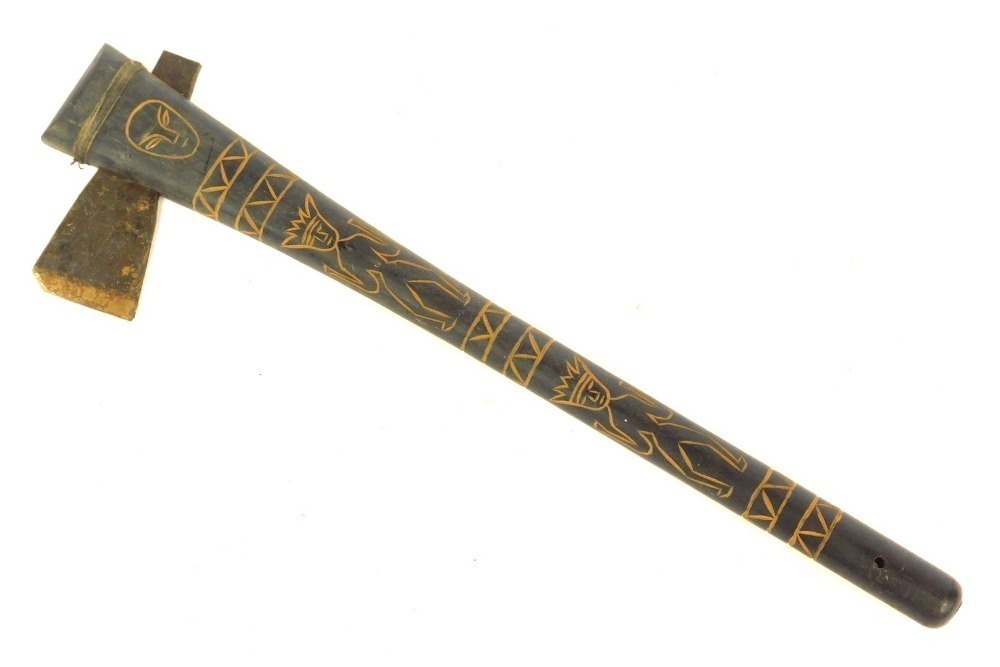 A carved tribal axe, with Aztec carved decoration, with axe head, and ...