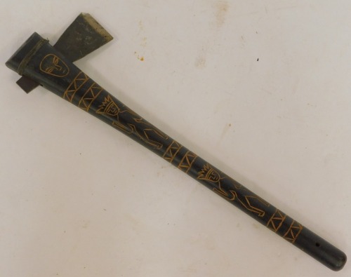 A carved tribal axe, with Aztec carved decoration, with axe head, and ...