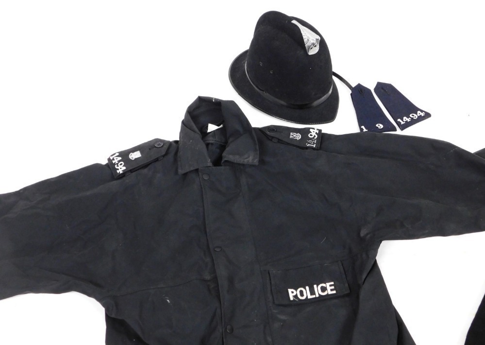 A vintage police uniform, comprising coat and weatherproof jacket, with ...