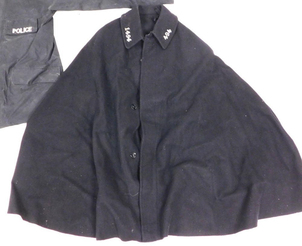 A vintage police uniform, comprising coat and weatherproof jacket, with ...