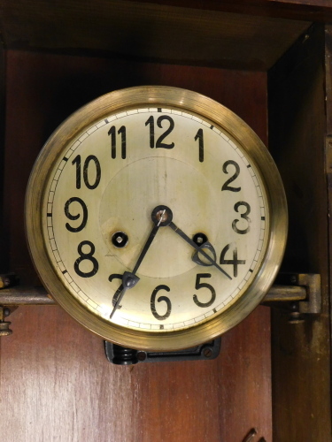 A 1920s wall clock, in walnut case, silvered dial with Arabic numbers ...