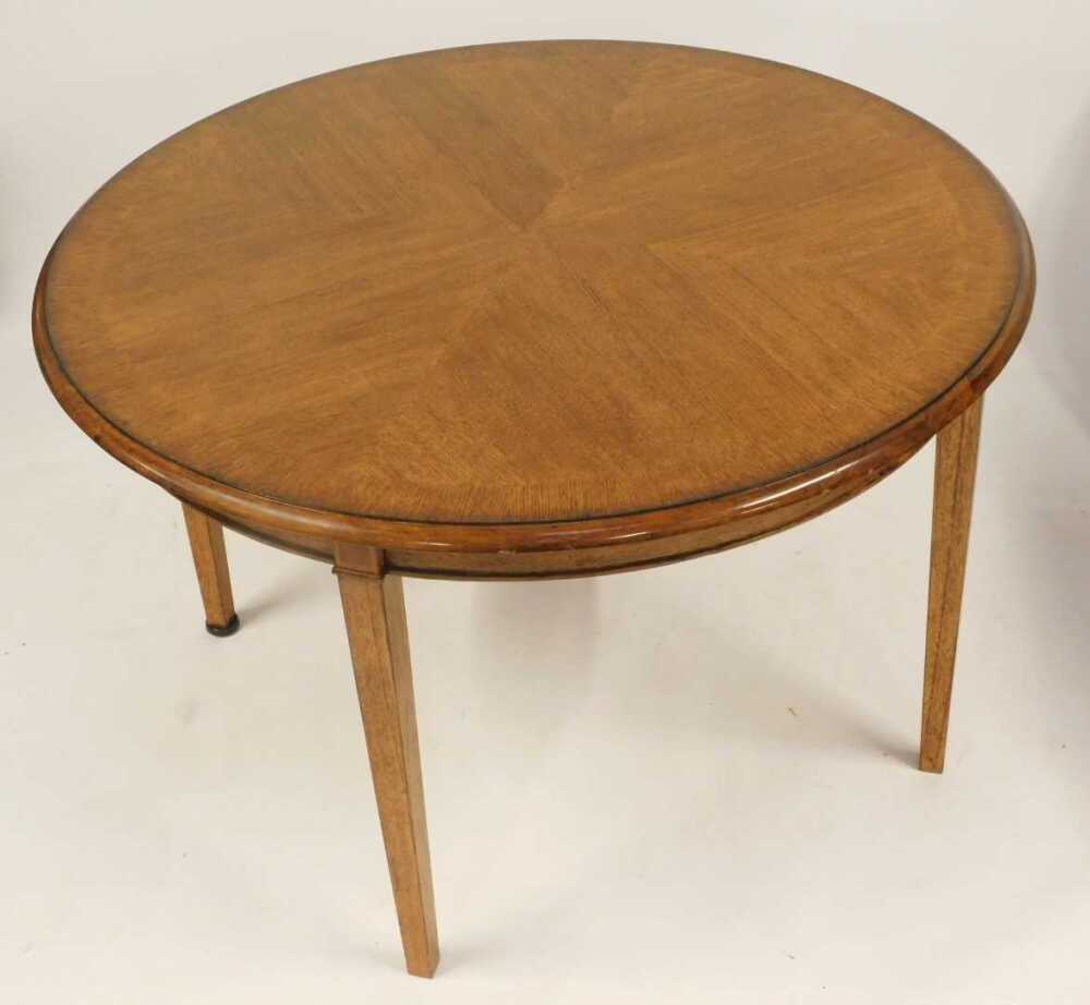 A 20thC oak and cross banded dining table, the circular top raised on ...
