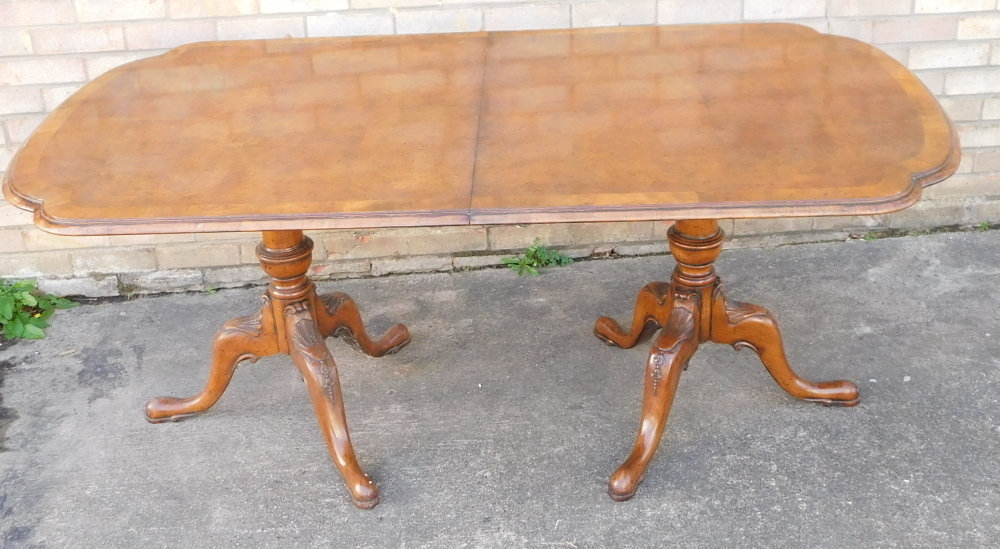 A Titchmarsh and Goodwin figured walnut extending dining table, the ...