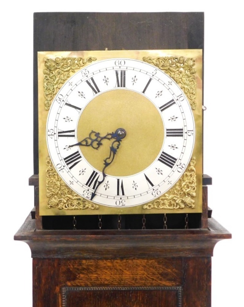 An early 20thC oak longcase clock, square brass dial with cherub and ...