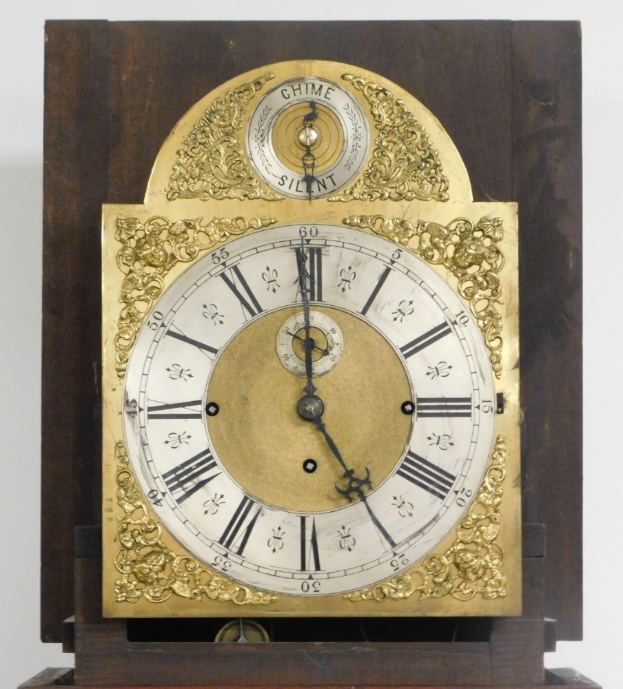 An Edwardian mahogany and satinwood longcase clock, the brass break arch dial with foliate and ...