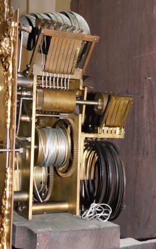 An Edwardian mahogany and satinwood longcase clock, the brass break ...