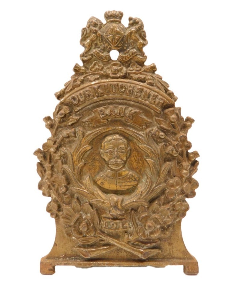 A gilt coloured cast iron money box, decorated with the Lord Kitchener ...
