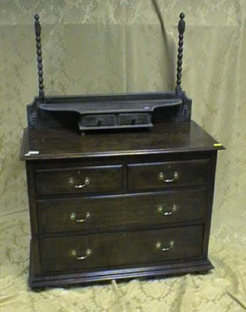 An oak chest of 2 short and 2 long graduated drawers with brass loop ...