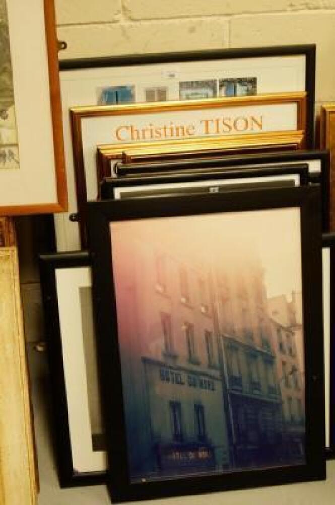 Framed reproduction posters and photographs.