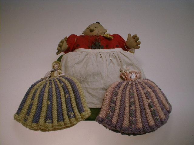 A felt German Haus Frau tea cosy and two porcelain half doll tea cosies