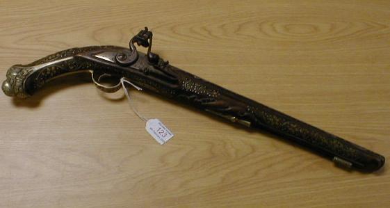 A flintlock pistol, with arabesque coloured metal inlays throughout