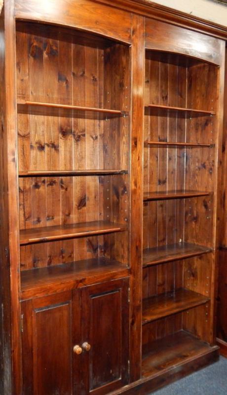 A stained pine cupboard bookcase