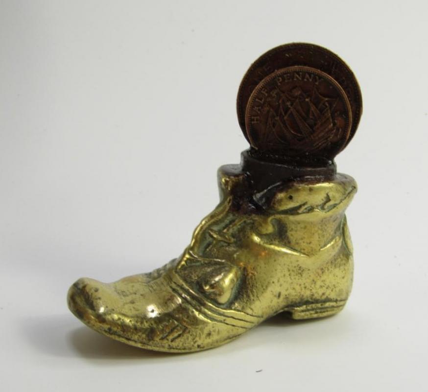 A set of six brass boot menu holders