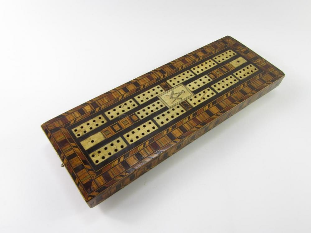 A Victorian masonic tunbridge ware and bone inlaid cribbage board