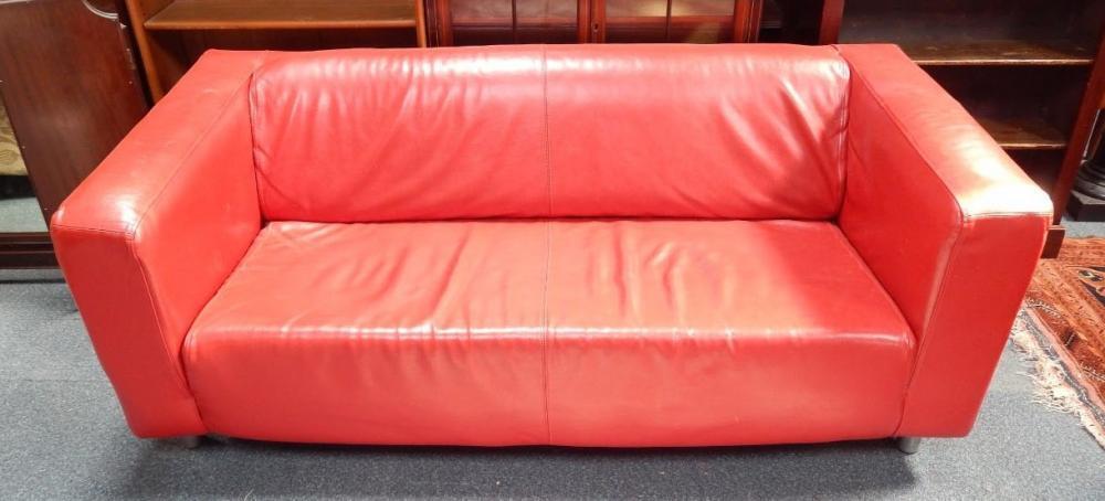 An Ikea France red leather two seater sofa