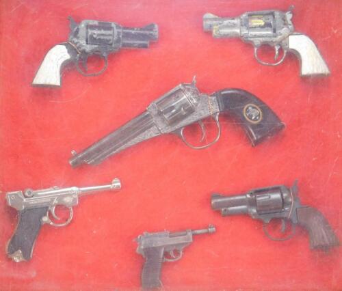 A cased set of miniature replica pistols
