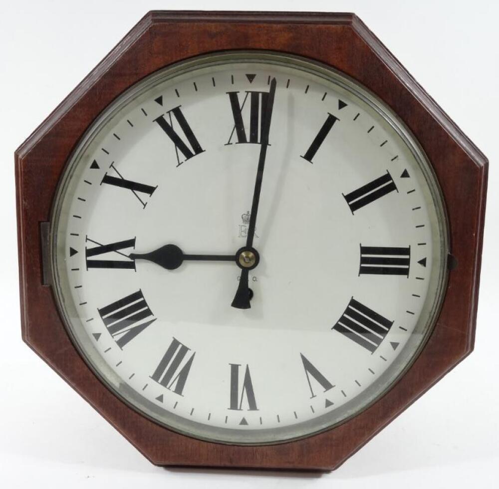 A GPO late 20thC mahogany octagonal cased double sided wall clock