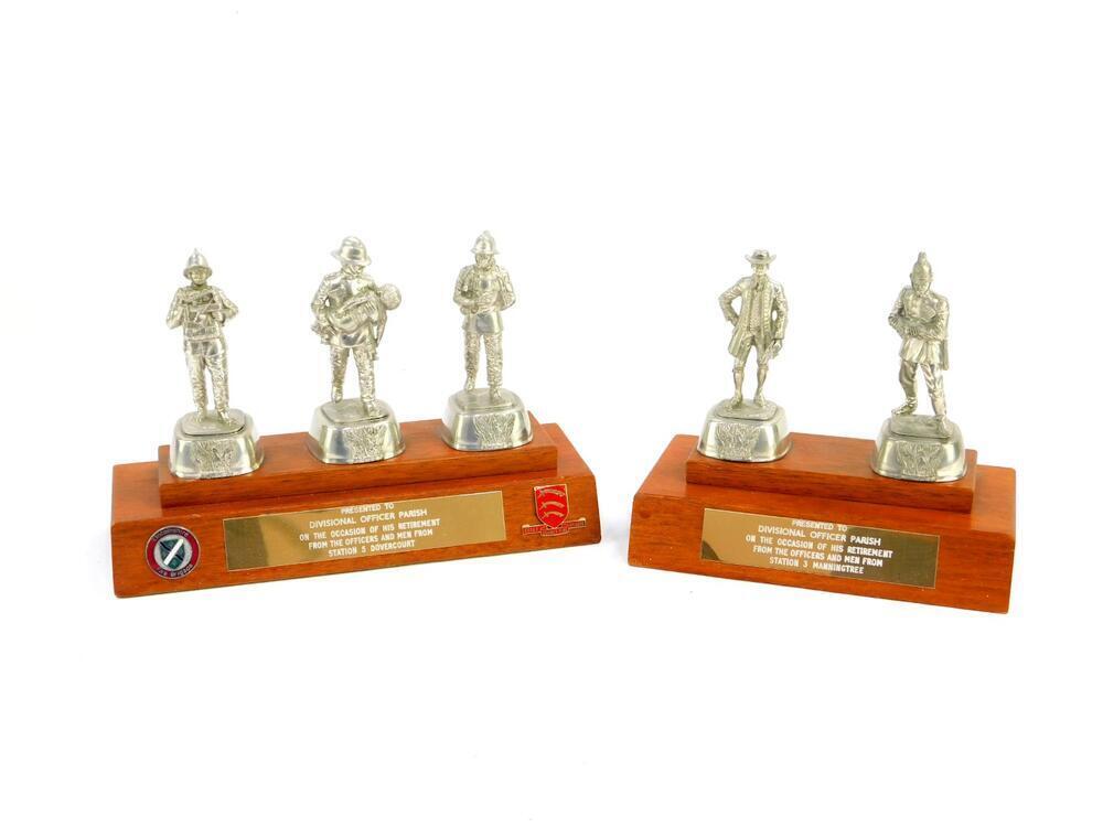 Five Charles C Stadden pewter figures of fireman, raised on two stepped ...