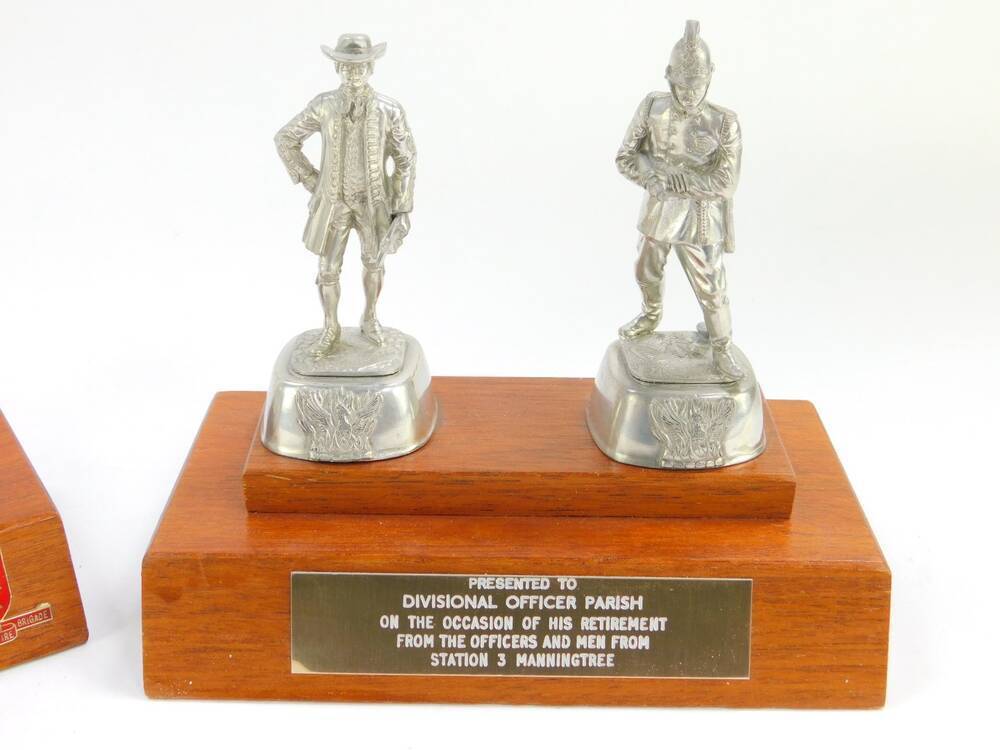 Five Charles C Stadden pewter figures of fireman, raised on two stepped ...