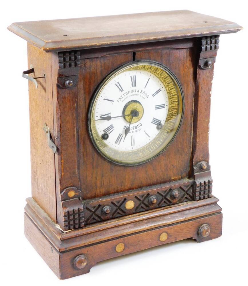 Fattorini. An early 20thC oak cased alarm mantel clock, the shaped case ...