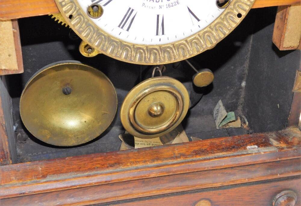 Fattorini. An early 20thC oak cased alarm mantel clock, the shaped case ...