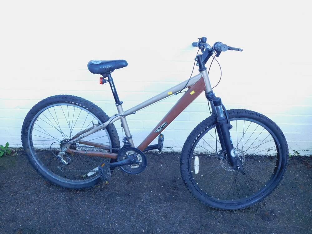 A Kalin Muc-Off mountain bike, in brown and silver.