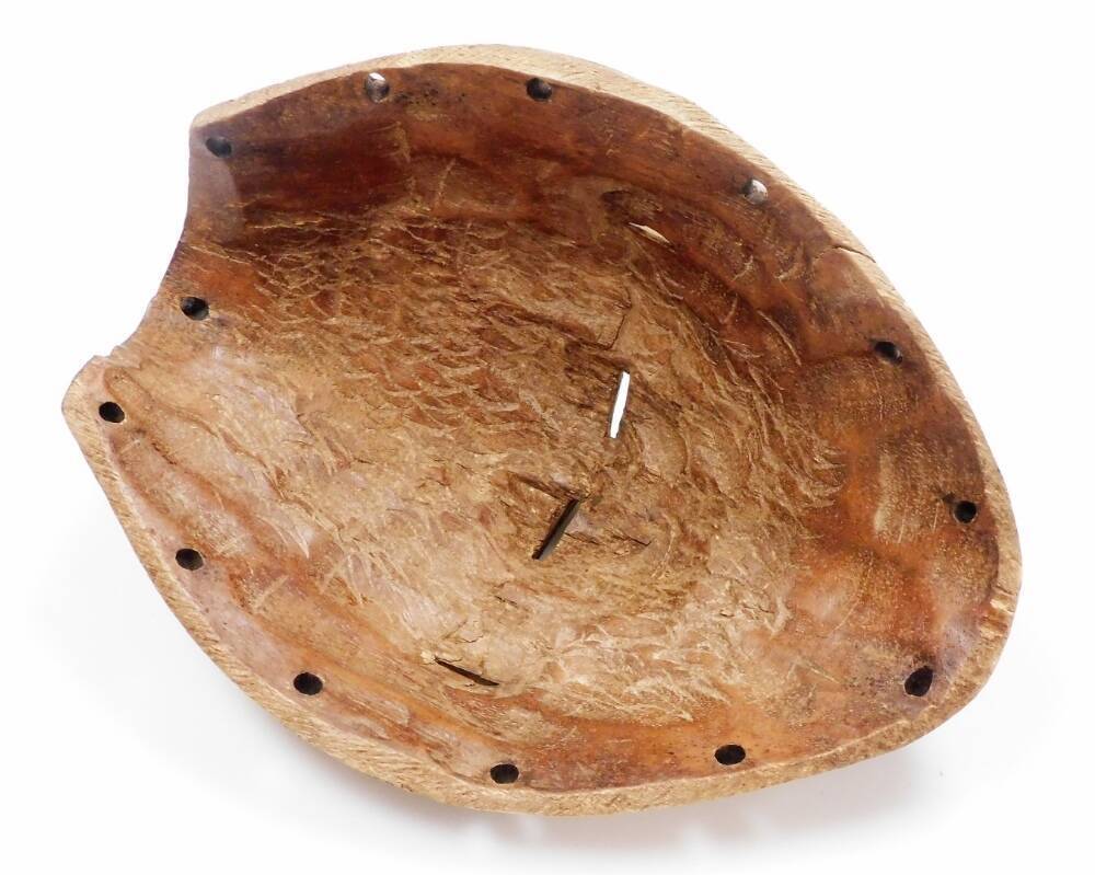 An African tribal face mask, of shaped ellipse form with pierced eyes ...