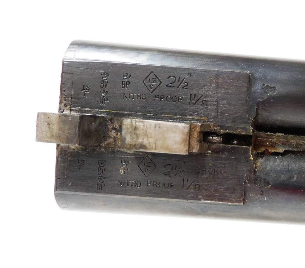 An English double barrel 12 gauge side by side shotgun, SN 11689.