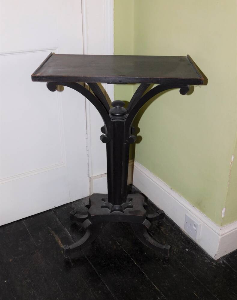 A 19thC ebonised stand, the rectangular top with a raised border on a ...