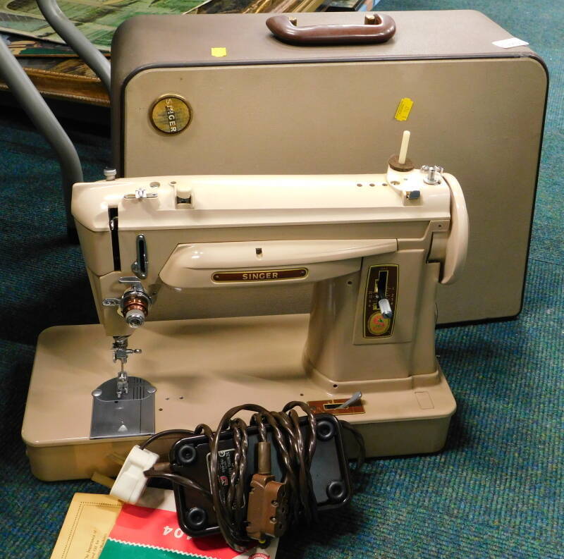A cased Singer Sewing machine.